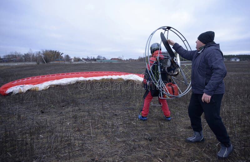 Paramotoring. Paramotorist Men Checking Equipment of Paramotor for ...