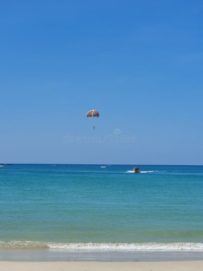 Parasailing Over Clear Blue Waters. Different Shades of Blue in the ...