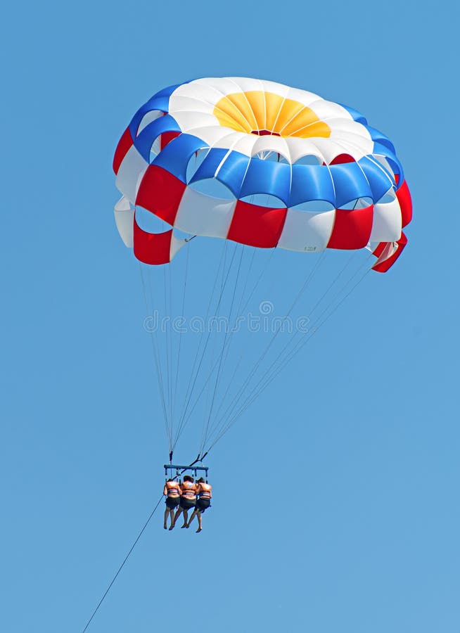 Three people parasailing stock photo. Image of rainbow - 9897928