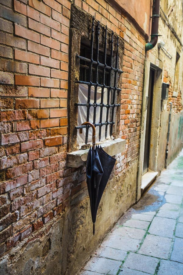 Parasol by the Window on the Background of an Old Brick Wall Stock ...