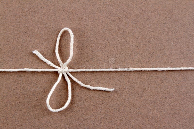 String Bow on Brown Paper stock photo. Image of recycled - 22999590