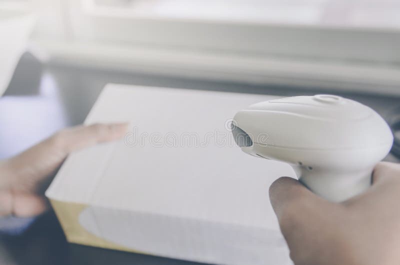 A Human Hand Holding Parcel with Barcode Reader for Delivery Stock ...