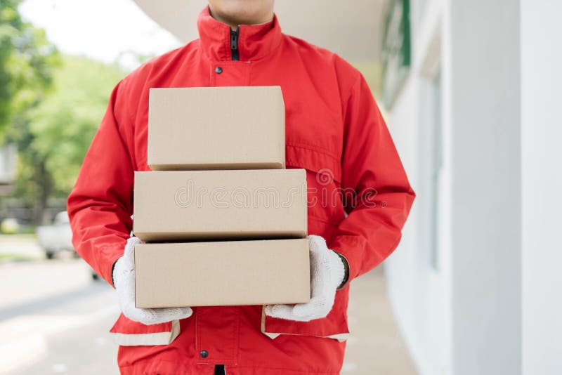 Parcel Delivery Concept the Mailman Standing, Holding Three Boxes of ...