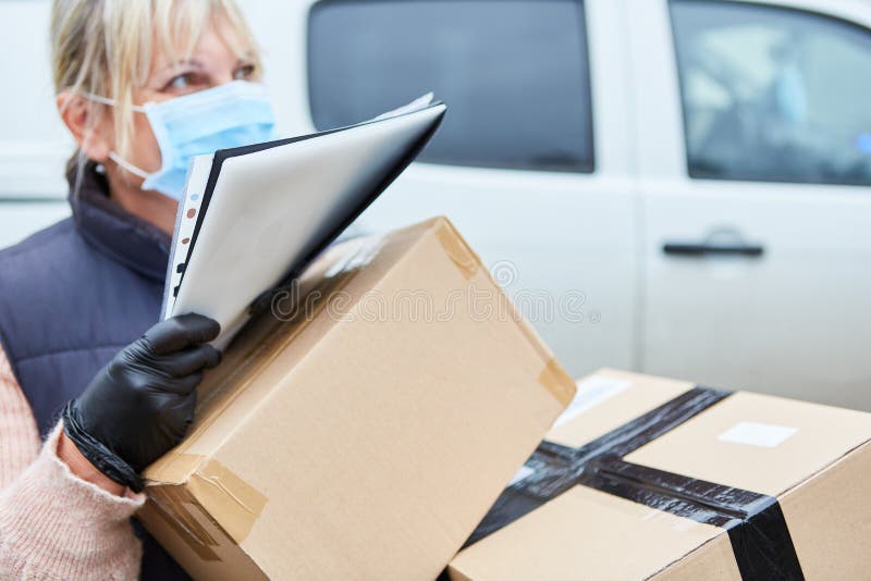 Parcel Messenger with Face Mask when Delivering Parcels Stock Image ...