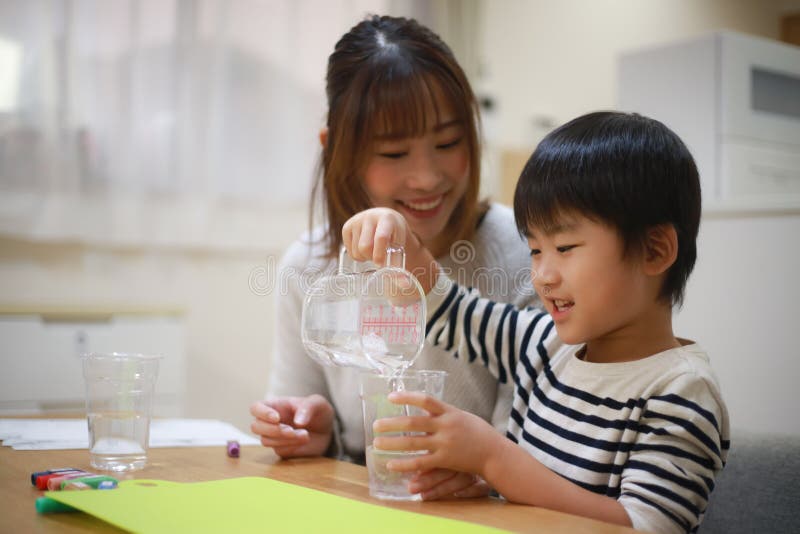 Parent and Child Making Slime Stock Photo - Image of experiment, paints ...