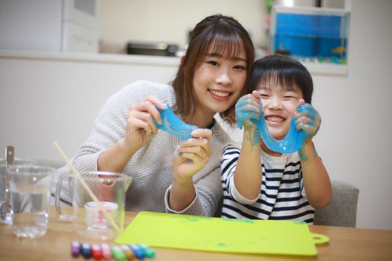 Parent and Child Making Slime Stock Image - Image of family, refreshing ...