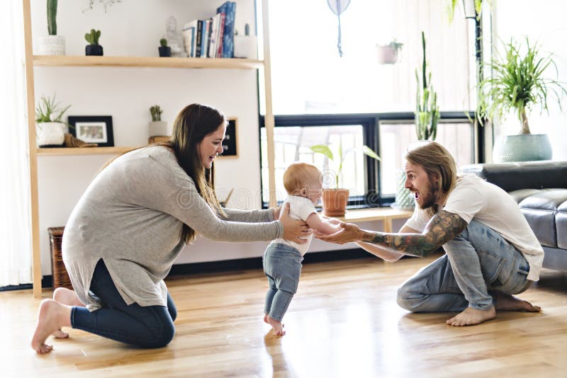 Parent Help Baby Daughter Take First Steps at Home Stock Image - Image ...