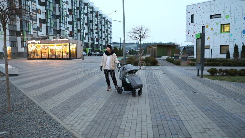 Parent Walking with Stroller in Urban Area during Early Evening Hours ...