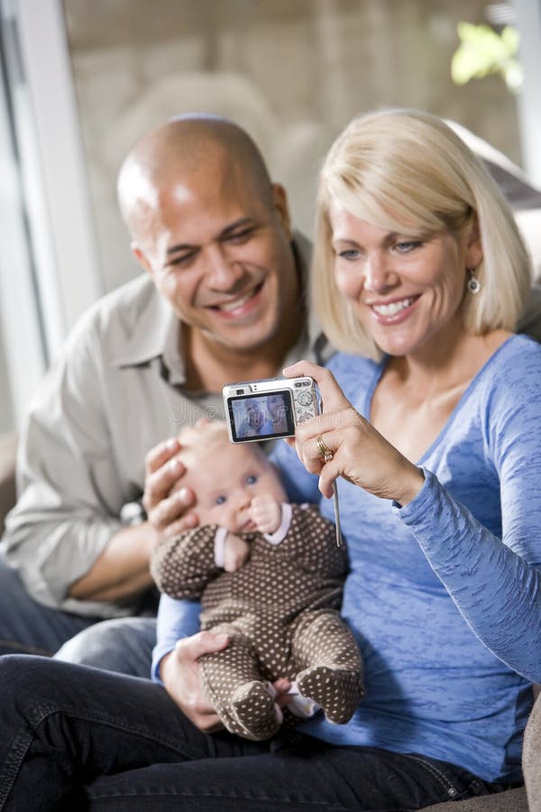 Parents with Baby at Home, Mom Holding Camera Stock Photo - Image of ...