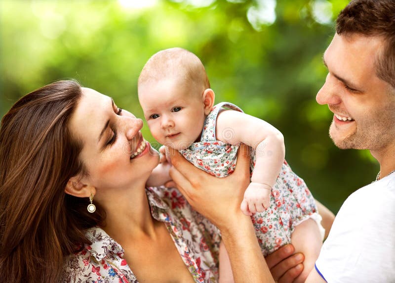 Parents with baby in park stock photo. Image of parent - 45068516