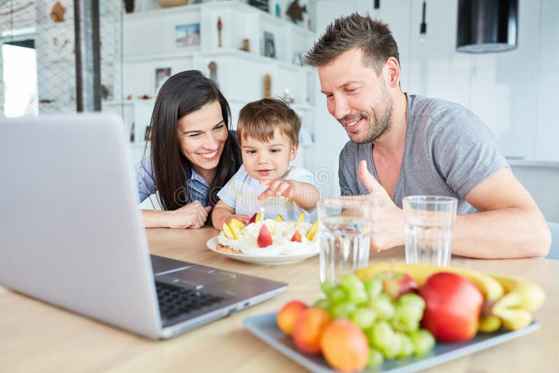 Parents and Child Eat Cake while Video Chat Stock Image - Image of ...