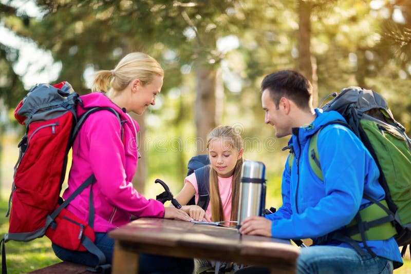 Parents and Child Girl Look Map in the Forest Stock Image - Image of ...