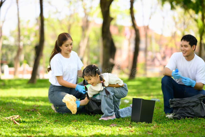 Parents and Child Picking Up Plastic Waste Together during a Park ...