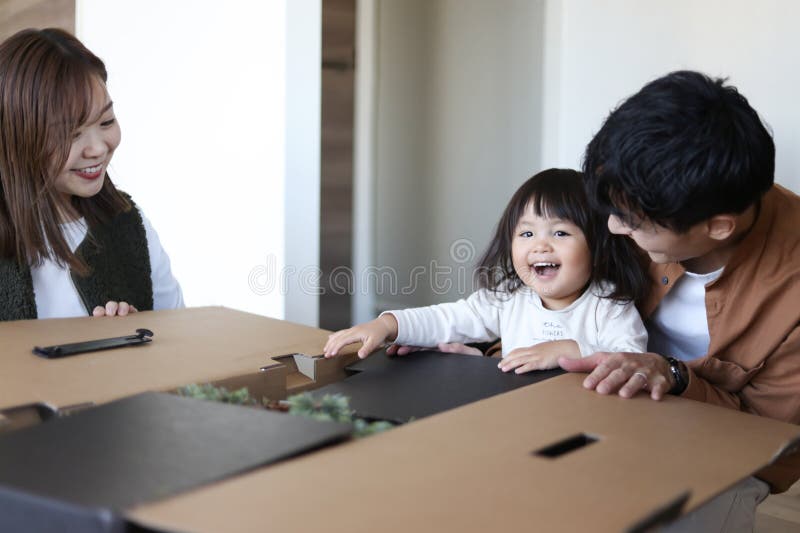 Parents and Children Assembling a Christmas Tree Stock Photo - Image of ...