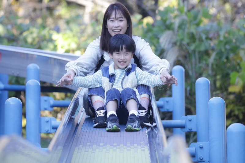 Parents and Children Playing on a Slide Stock Image - Image of ...