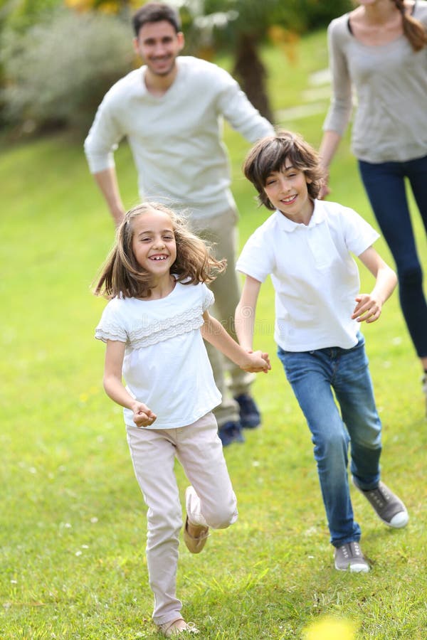 Parents and Children Running Outdoors Stock Image - Image of enjoying ...