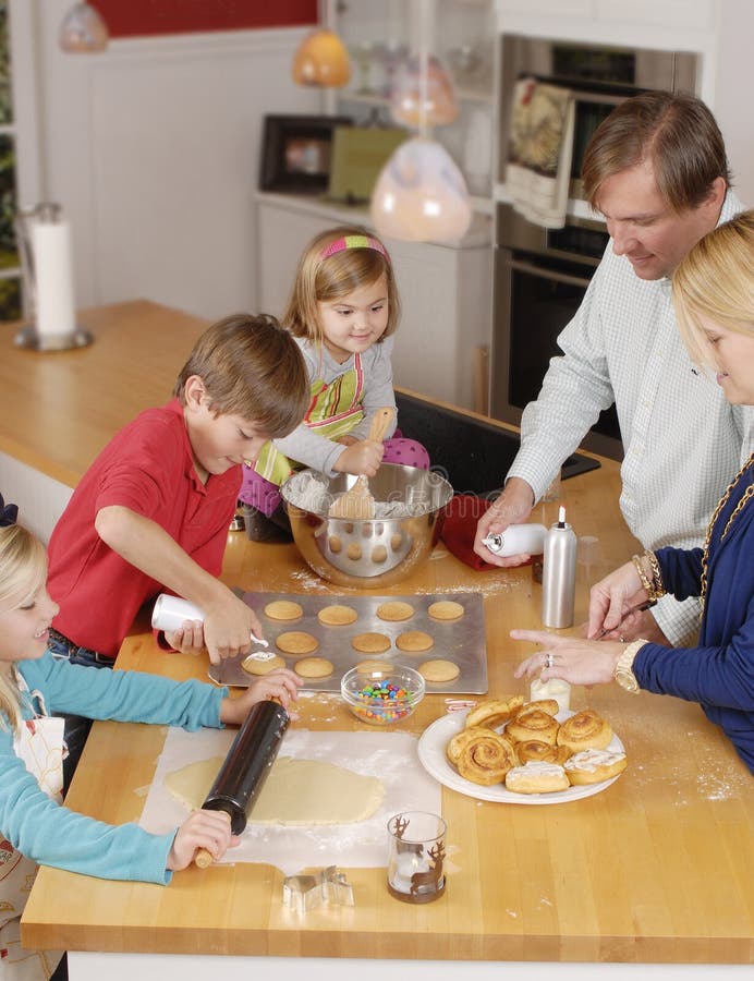 Parents Helping Children Baking In The Kitchen Stock Image - Image of ...
