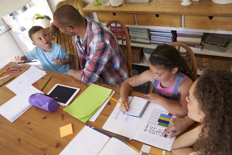Parents Helping Children with Homework at Table Stock Image - Image of ...