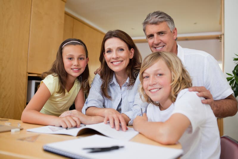 Parents Helping Their Children with Homework Stock Photo - Image of ...