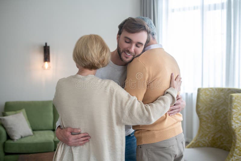 Parents Hugging Their Son and Looking Happy Stock Image - Image of ...