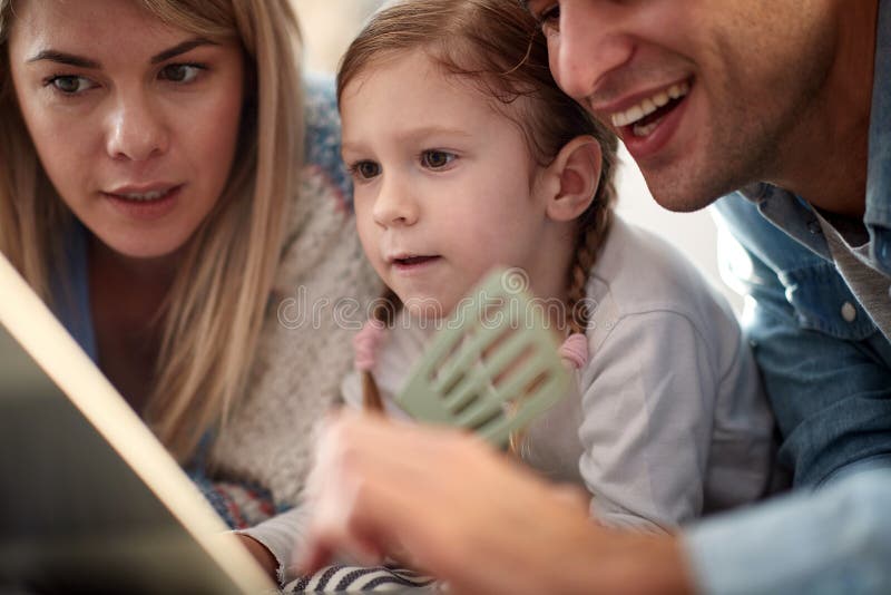 Parents Learning Together with Their Daughter Stock Photo - Image of ...