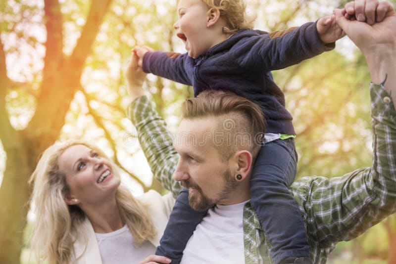 Parents with little boy stock image. Image of outdoors - 59075045