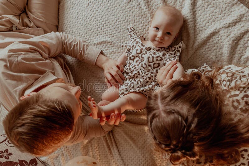 Parents, Mom and Dad with Little Baby on Bed Stock Image - Image of ...