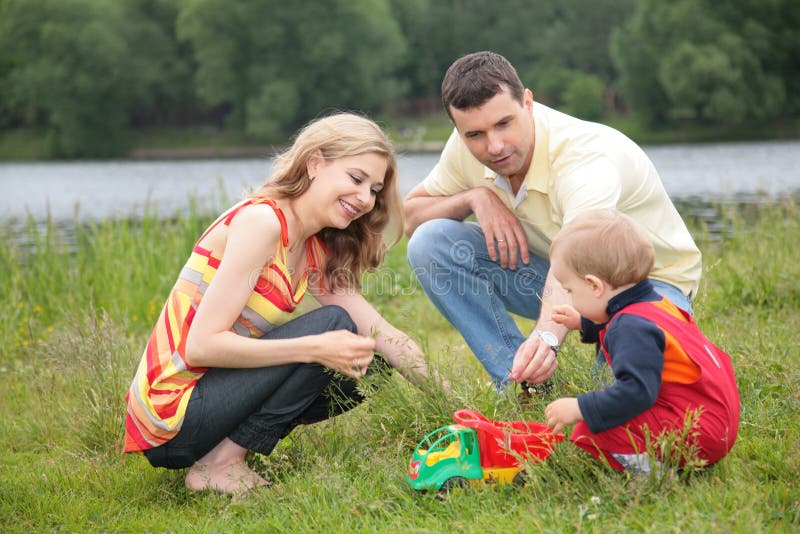 Parents Play With Child Outdoor Stock Image - Image of child, grass ...