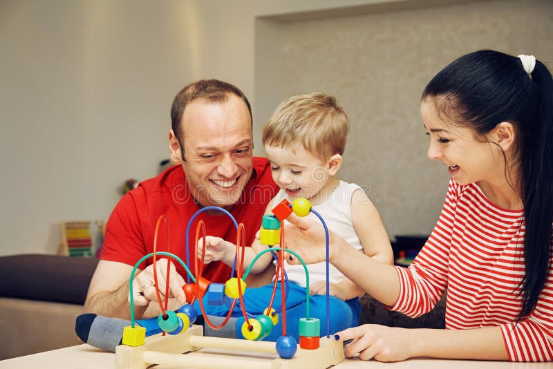 Parents Playing with Child in Developing Game Stock Image - Image of ...