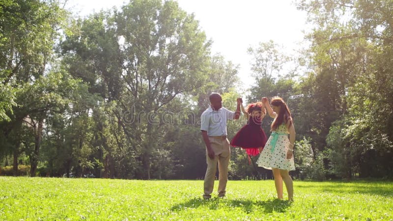 Parents Raise Their Daughter Holding Hands in Stock Footage - Video of ...