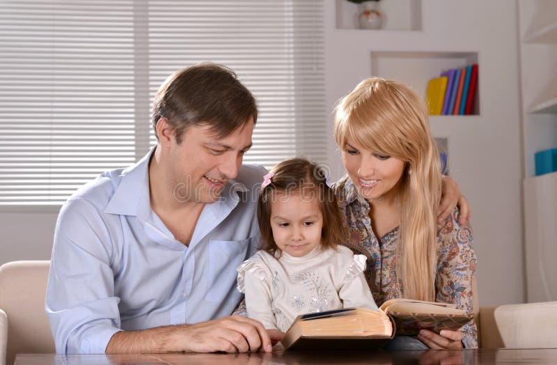 Parents Reading a Book Their Daughter Stock Photo - Image of friend ...
