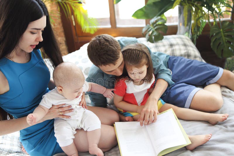 Parents Reading the Book To Their Children Stock Image - Image of ...