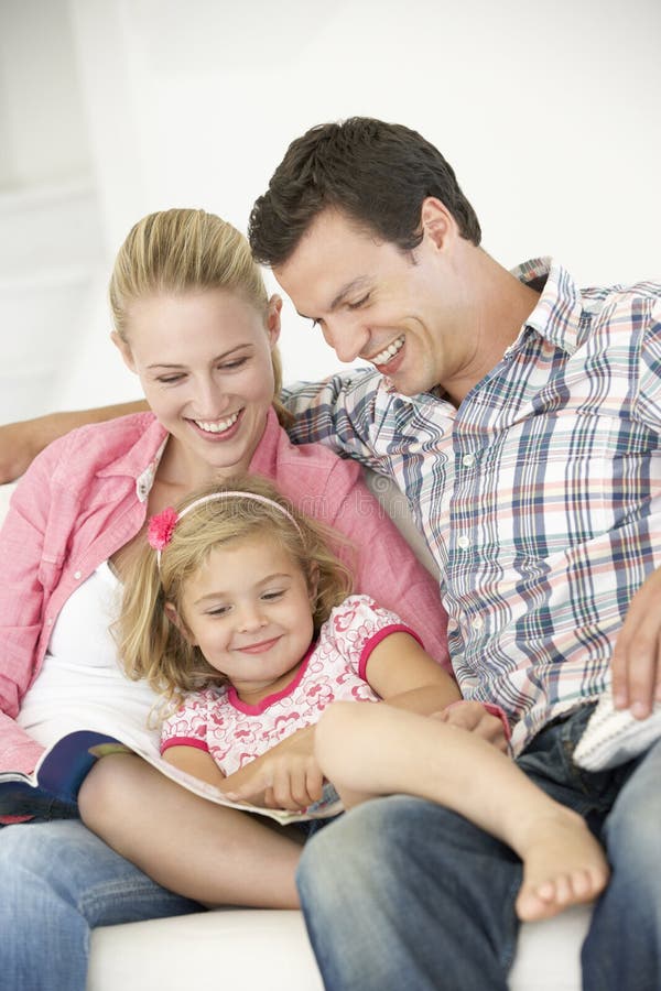 Parents Reading with Daughter at Home Stock Photo - Image of twenties ...