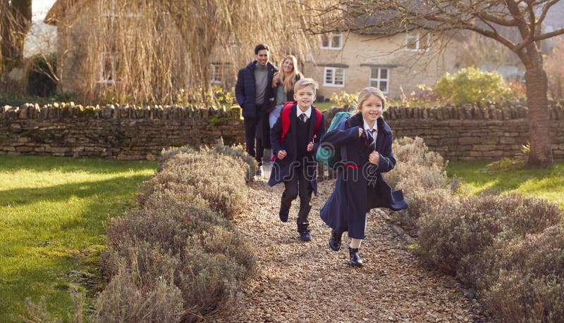 Parents Returning Home from School with Children Wearing School Uniform ...