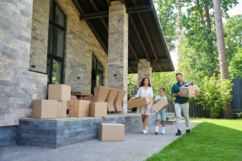 Parents and Son Move Boxes with Things To New House Stock Image - Image ...