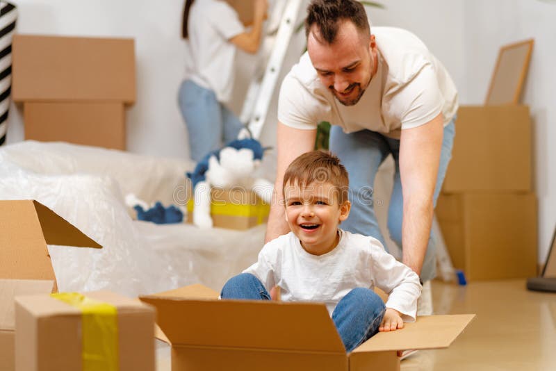 Parents and Son Packing Boxes and Moving into a New Home Stock Image ...