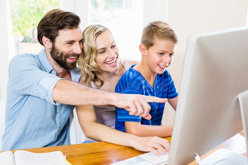 Parents and Son Using Computer in Living Room Stock Image - Image of ...