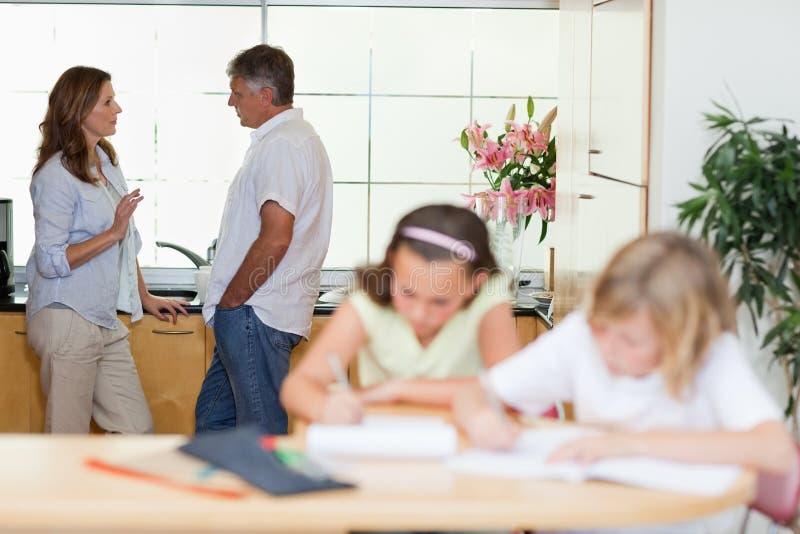Parents Talking with Children Doing Homework in Front of Them Stock ...