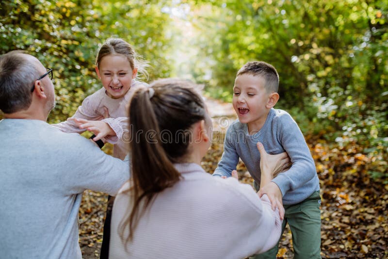 Parents with Their Little Children Having Fun in Forest. Stock Image ...