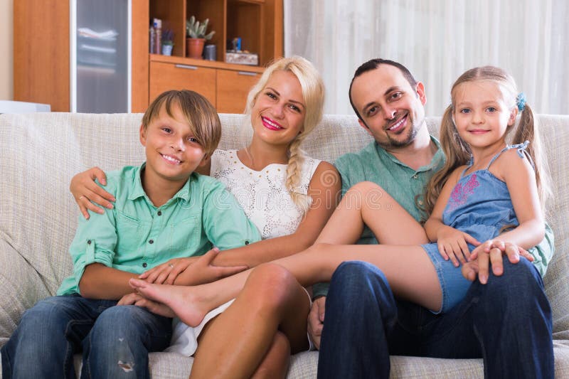 Parents with Two Children Posing in Home Interior Stock Photo - Image ...