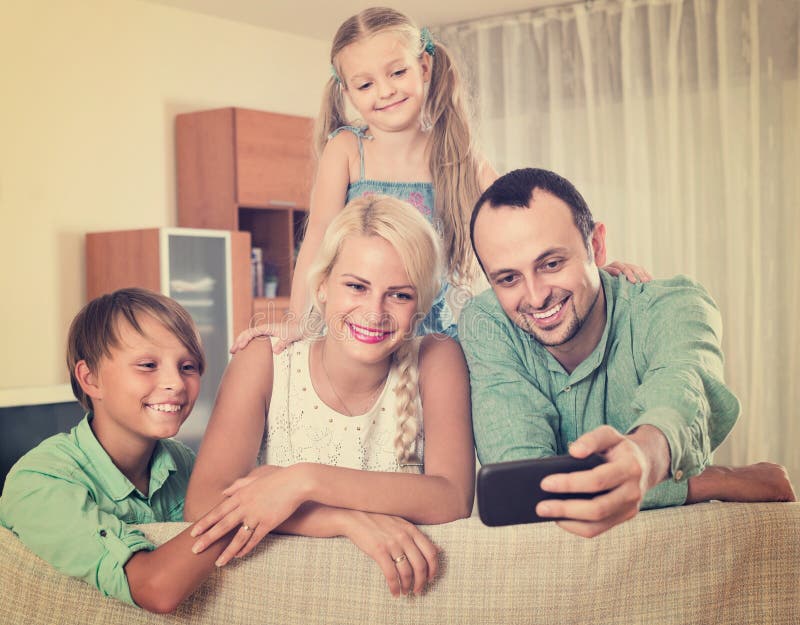 Parents with Two Children Posing in Home Interior Stock Image - Image ...