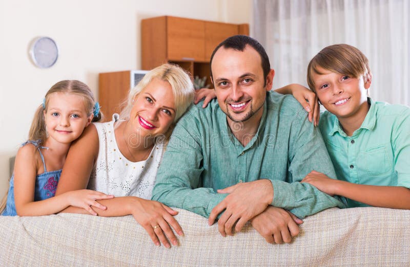 Parents with Two Children Posing in Home Interior Stock Photo - Image ...