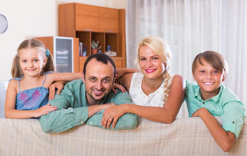 Parents with Two Children Posing in Home Interior Stock Image - Image ...