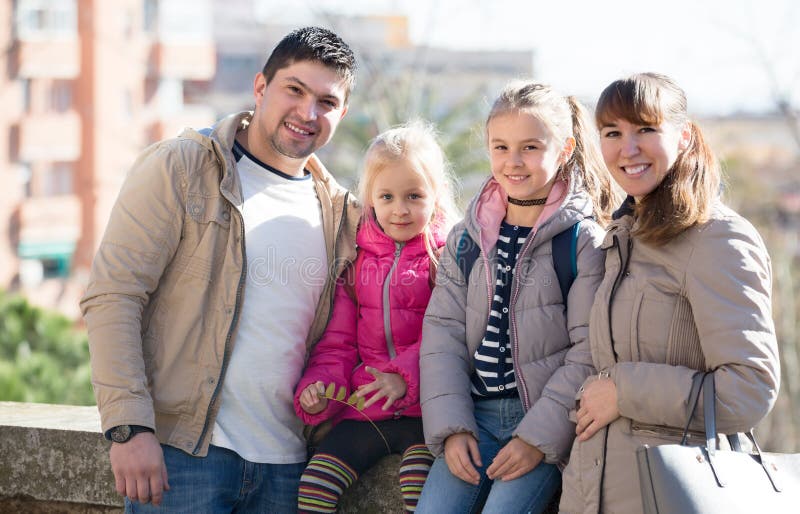 Parents with Two Daughters Smiling Outdoors Stock Photo - Image of city ...