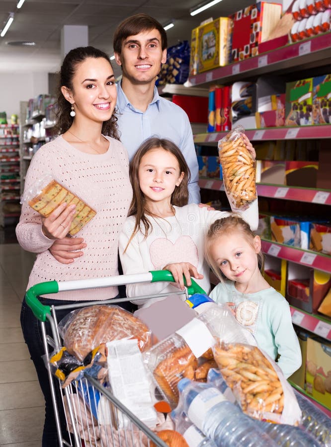 Parents with Two Kids Choosing Biscuits in Store Stock Image - Image of ...