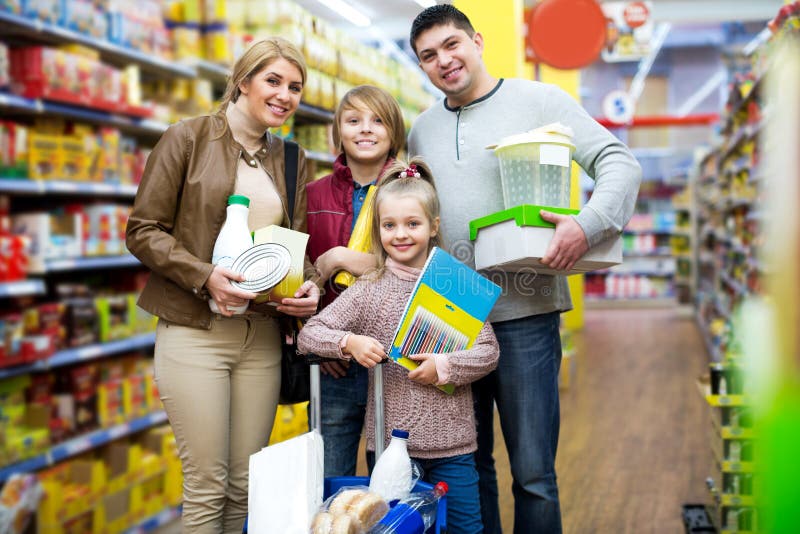Parents with Two Kids Holding Purchases in Store Stock Image - Image of ...