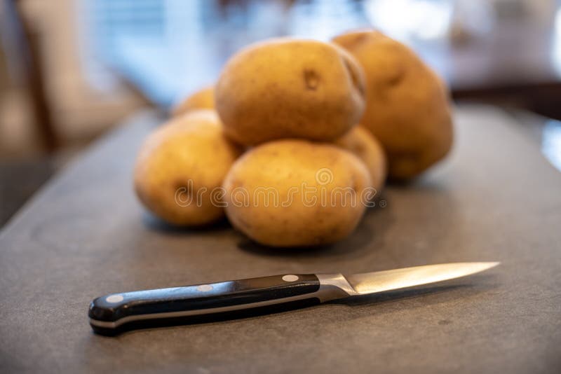 Paring Knife Sits on Cutting Board with Yukon Gold Potatoes Stock Image ...