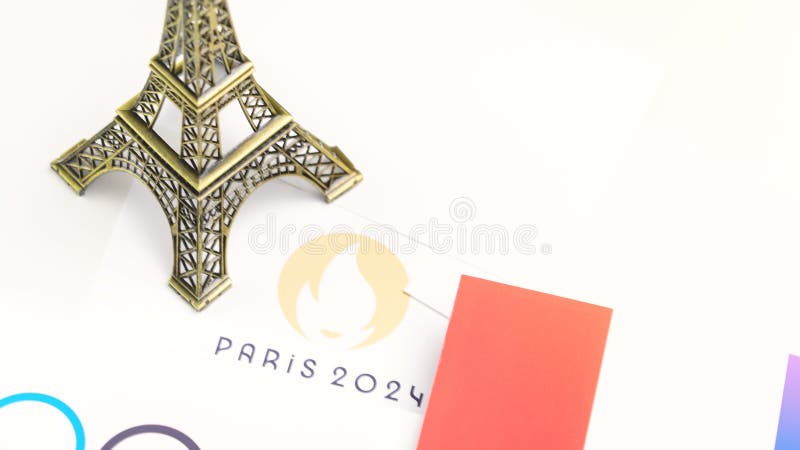 A Paris 2024 Olympic Flag is on Top of a Paper with a Circle Design ...