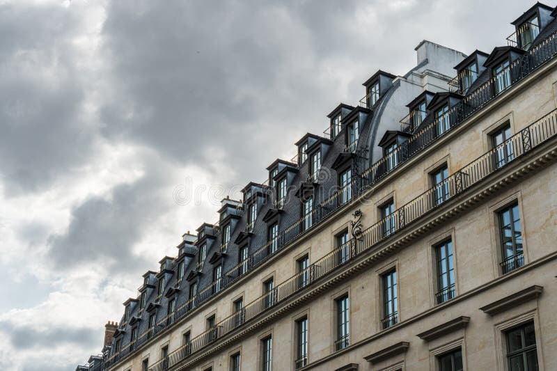 Parisian Building Facade with Dormer Windows Showing Cloudy Sky in ...
