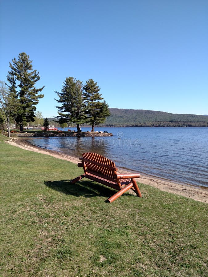 Park bench on public beach stock photo. Image of bench - 54603144